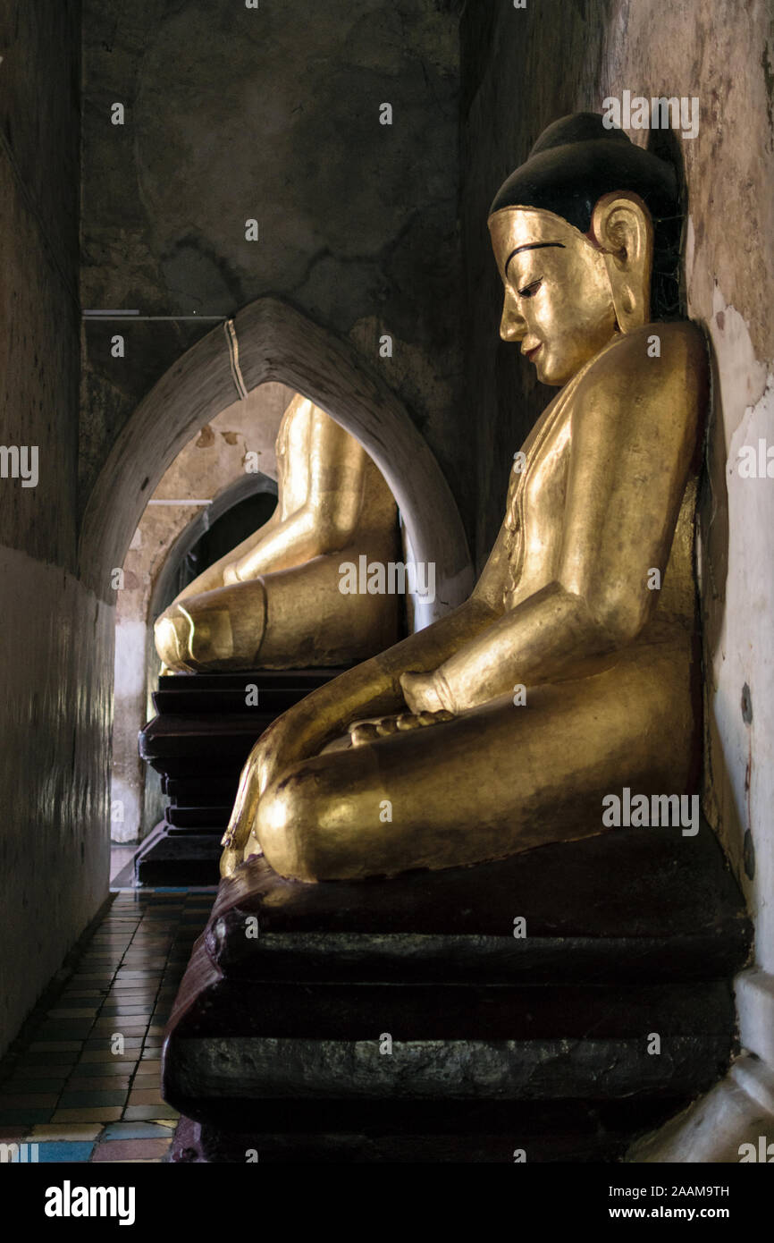 Sitting Buddha statue in one of the atmospheric corridors of ...