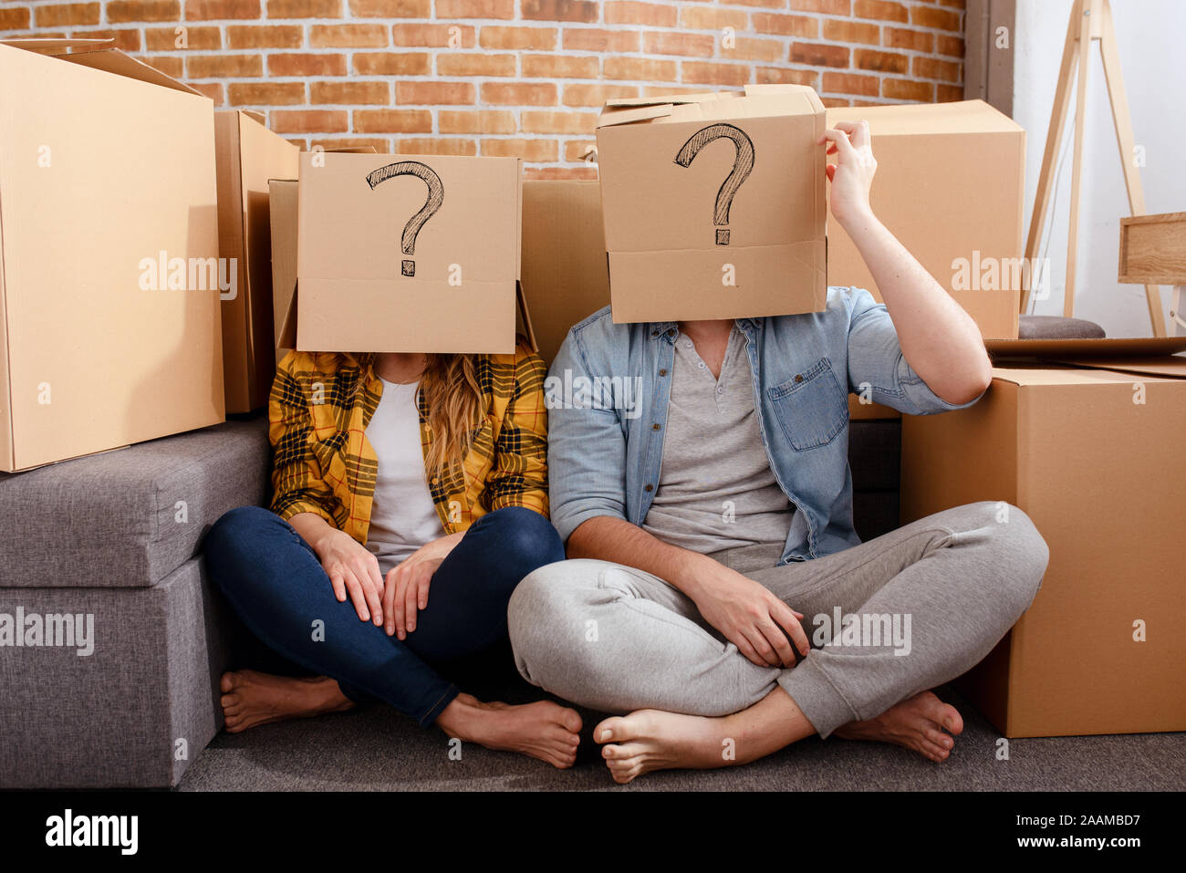 Confused couple of having to move and arrange all the packages. Concept ...