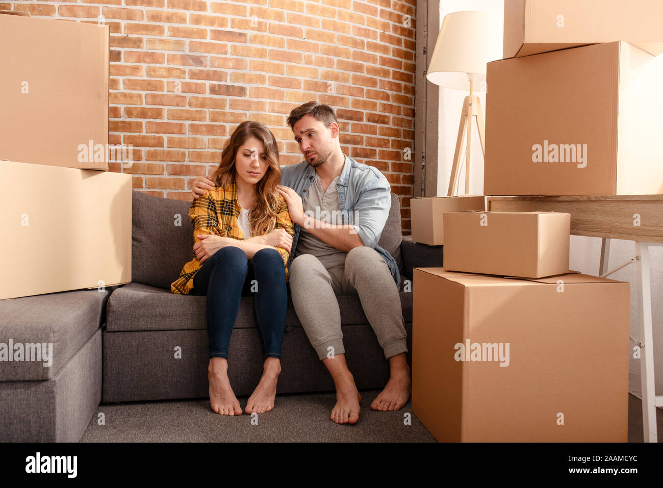 Confused couple of having to move and arrange all the packages. Concept ...