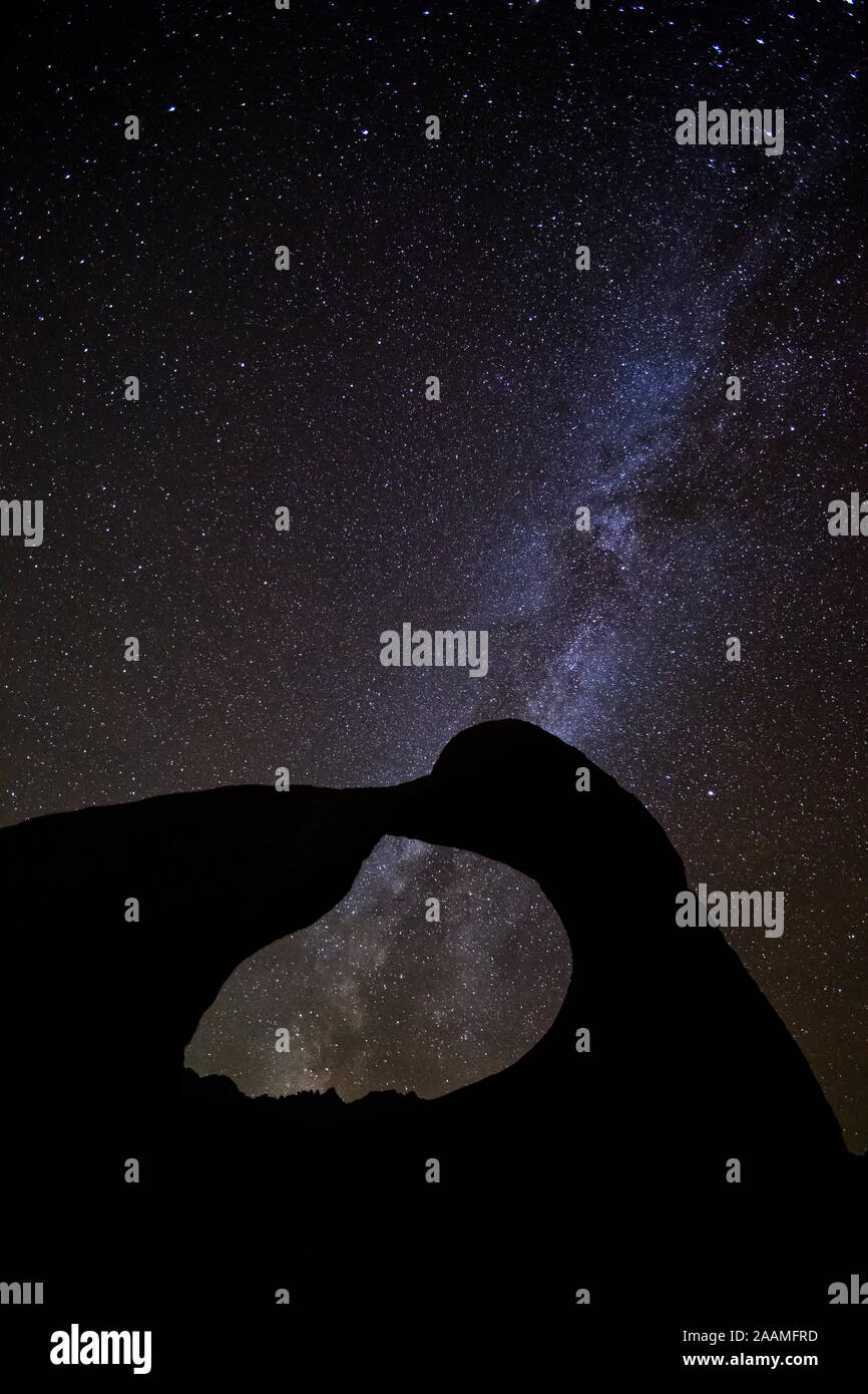 Silhouette of thin arch with night sky above. Starry night with Milky ...