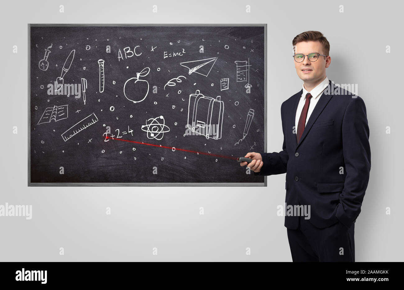 Handsome young teacher with laser pointer teaching Stock Photo - Alamy