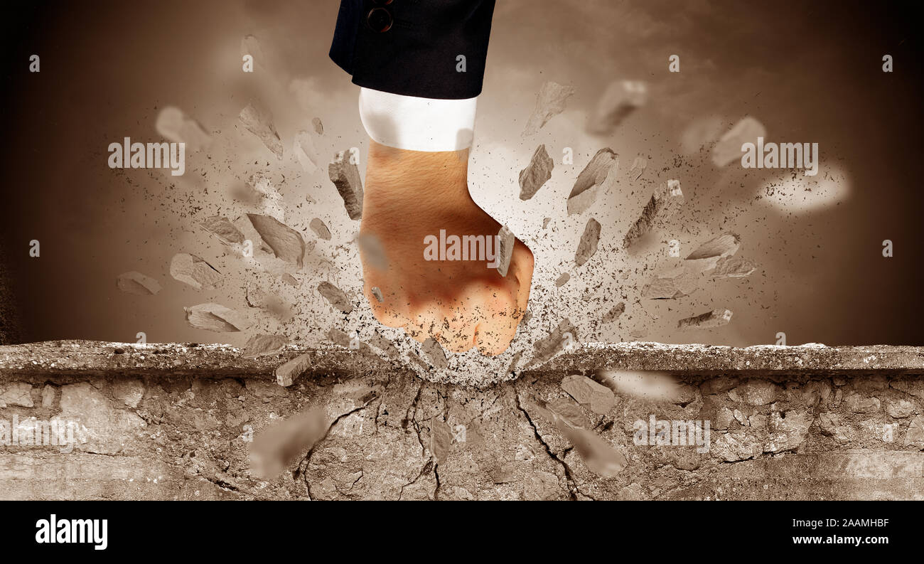 Big hand hits intense and breaks a crass stonewall Stock Photo - Alamy