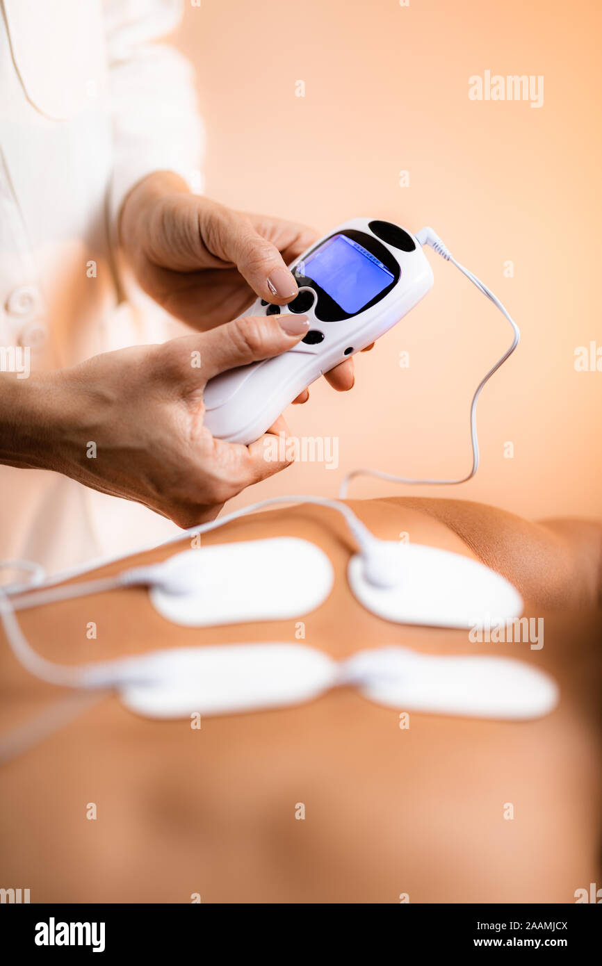 Physical therapy with TENS machine Stock Photo - Alamy
