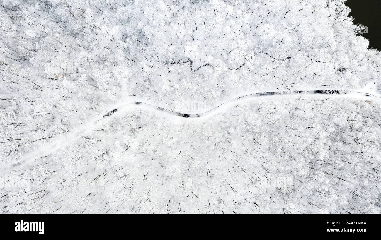 A drone / aerial view of a path covered with snow and ice Stock Photo ...