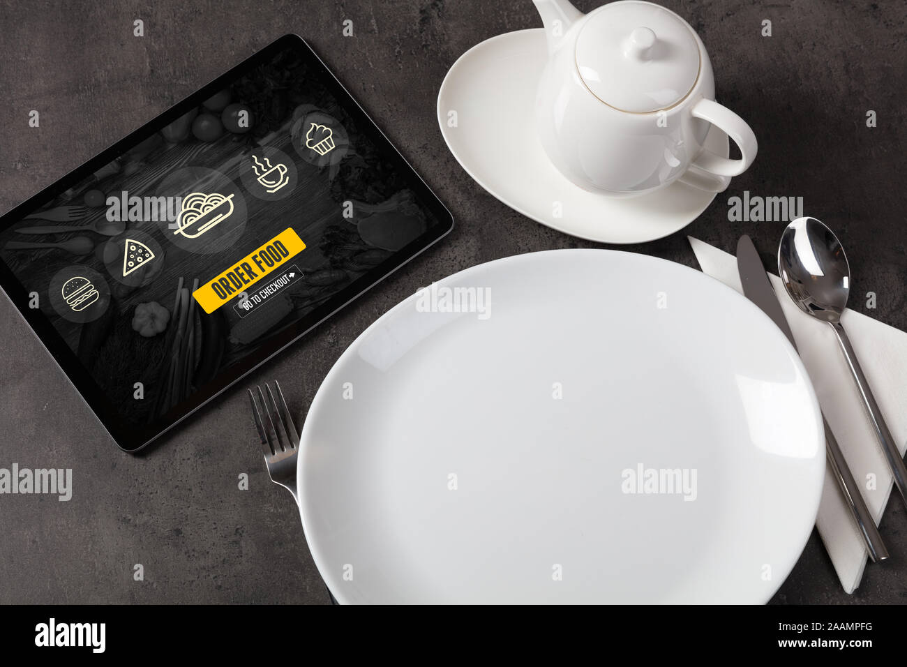 Online fast food order concept on a laid table Stock Photo - Alamy