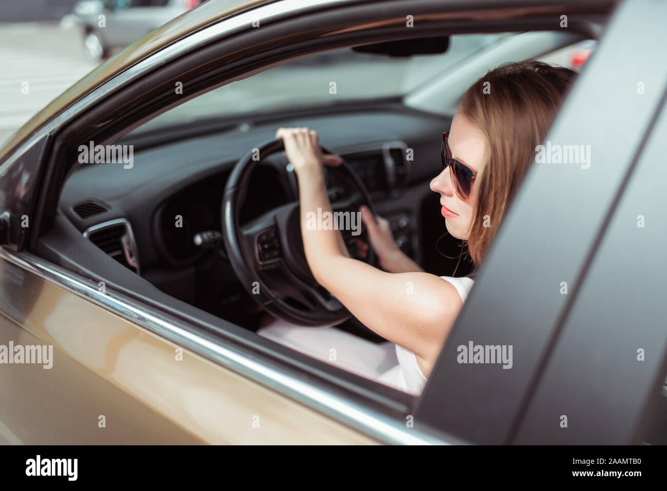 Woman driving reversing car looking hi-res stock photography and images ...