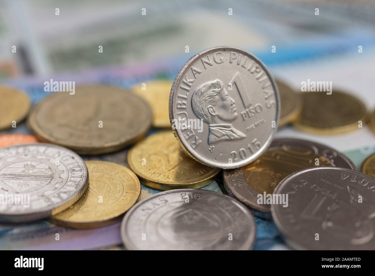 Cash banknote of one thousand Philippines peso and coins paying bills ...