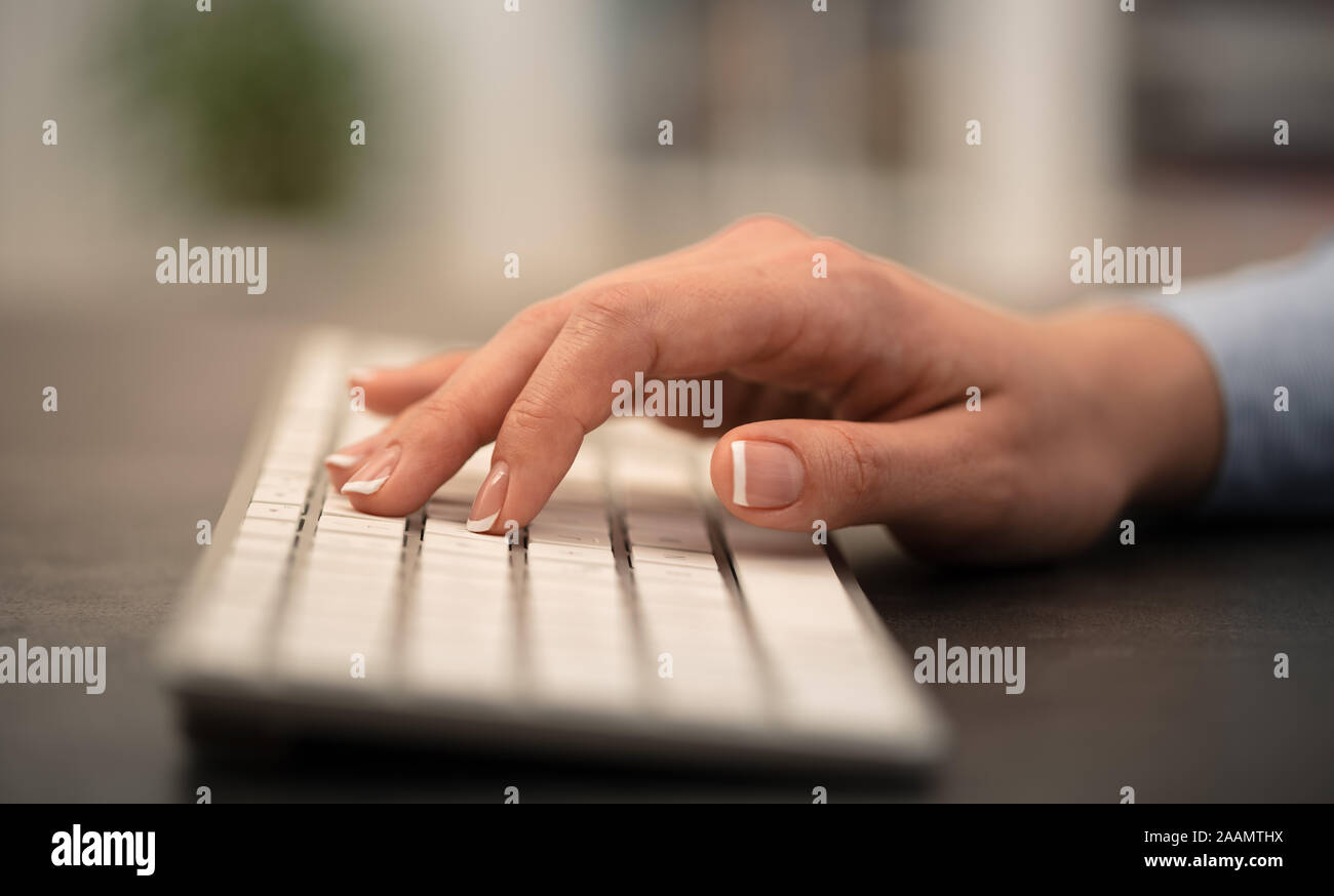 Hand typing on keyboard with office concept Stock Photo - Alamy