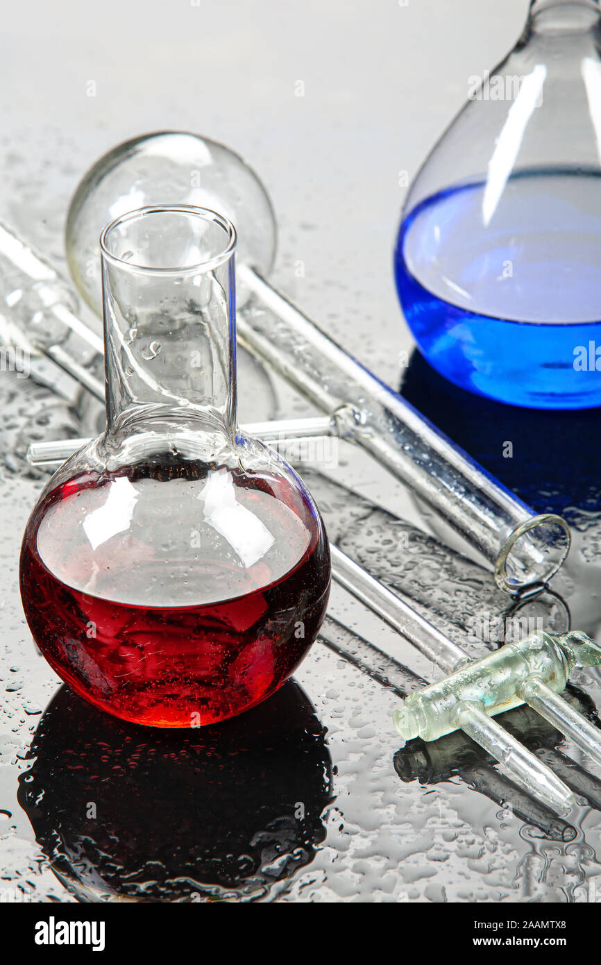 Chemical glassware on a glass studio background Stock Photo - Alamy