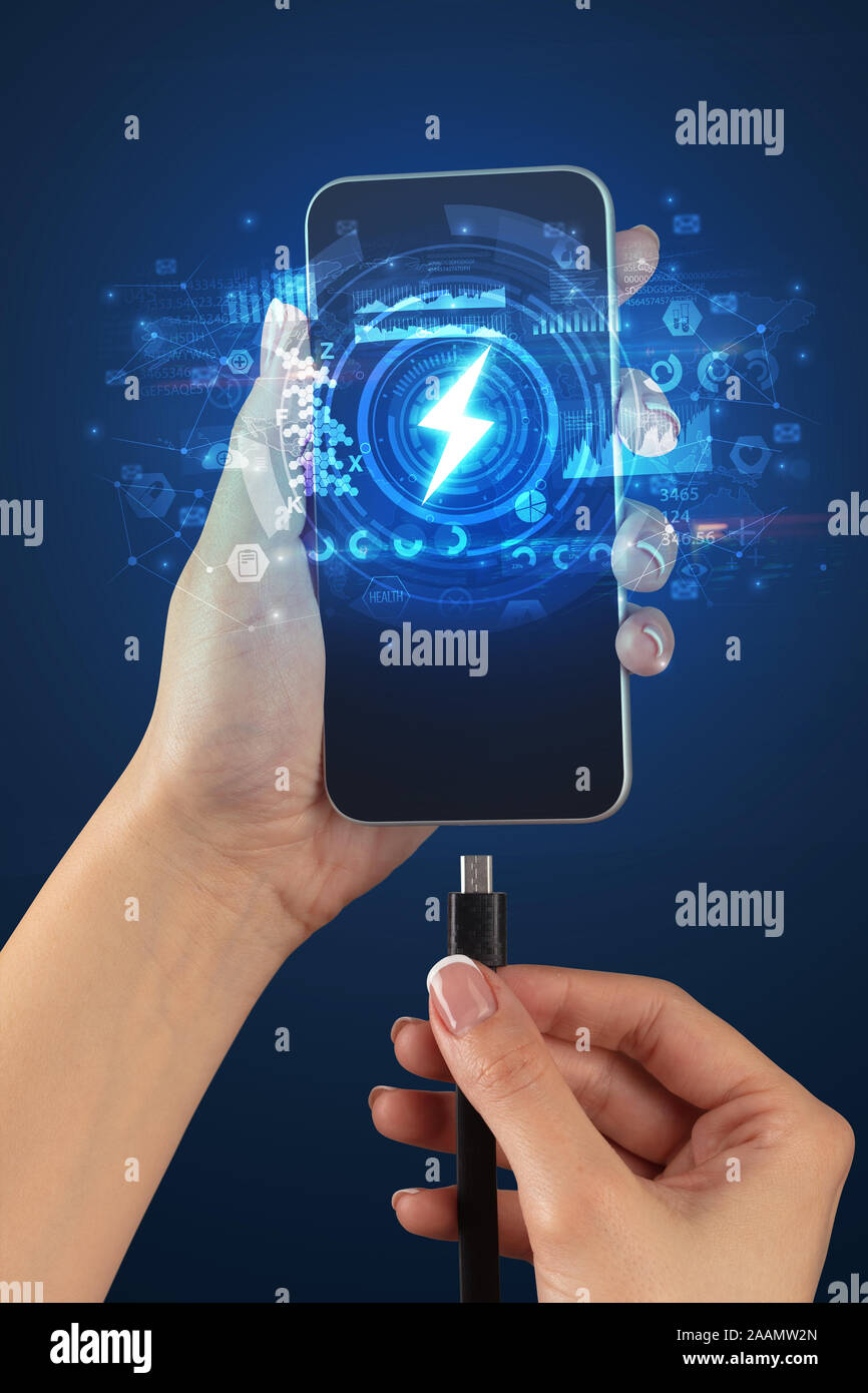 Elegant hand charging smartphone with global report concept Stock Photo ...