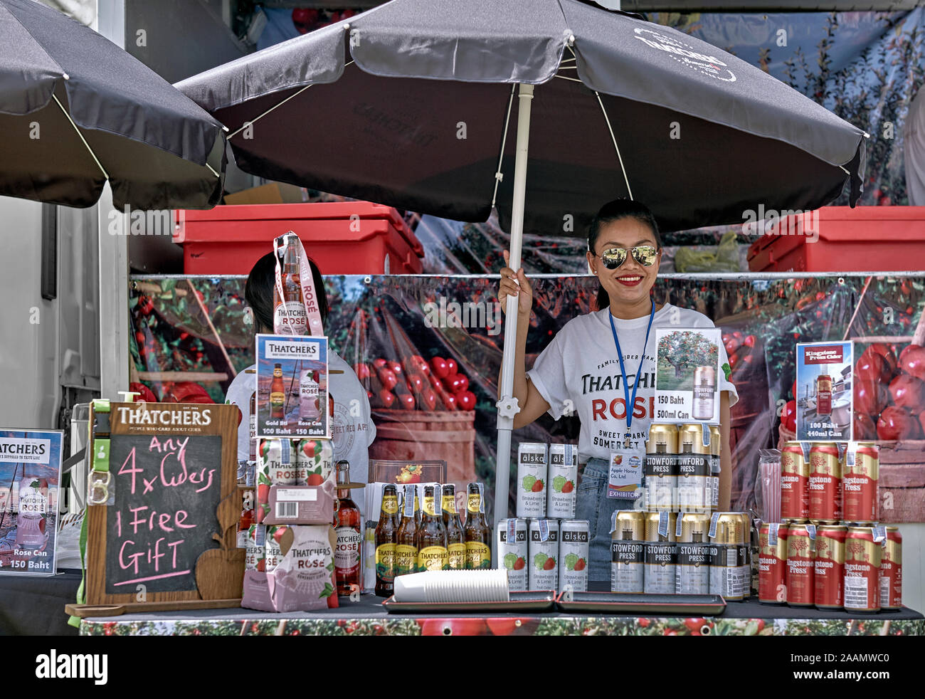 Thatchers cider stall with female attendants selling drinks. Alcohol ...