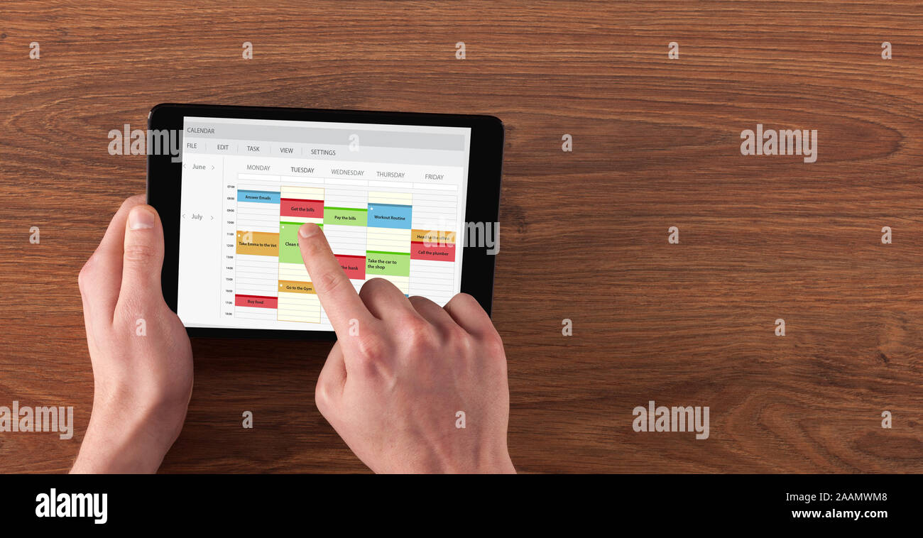 Hand holding tablet with timetable and calendar concept Stock Photo - Alamy
