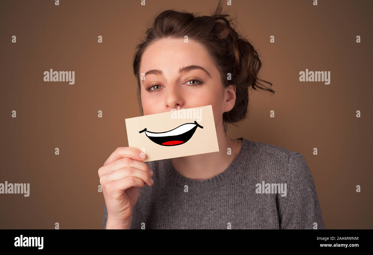 Person holding card in front of his mouth with ironic smile Stock Photo ...