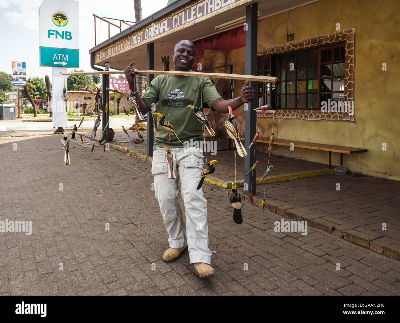 African street vendor, trader, hawker showing his traditional wooden ...