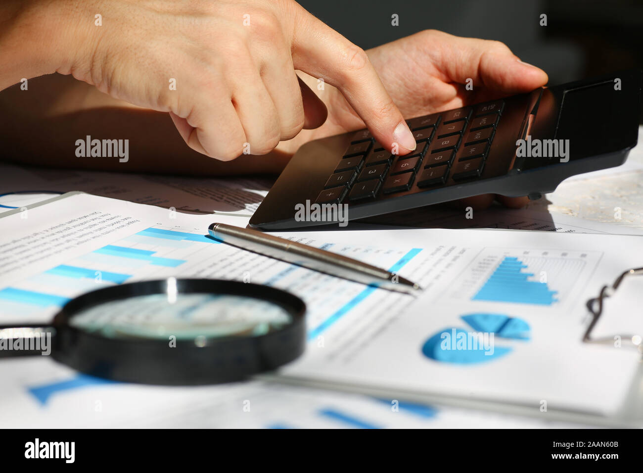 Black calculator and financial statistics on infographics Stock Photo ...