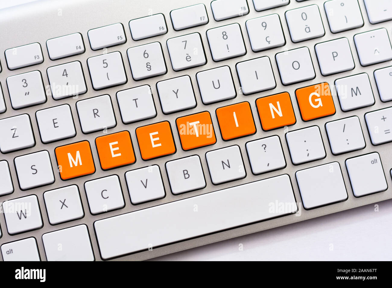 MEETING writing on white keyboard Stock Photo - Alamy