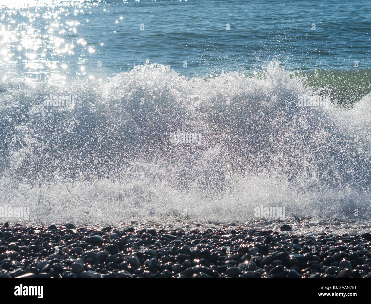 Big wave with water splashing in the sunlight on the beach Stock Photo ...
