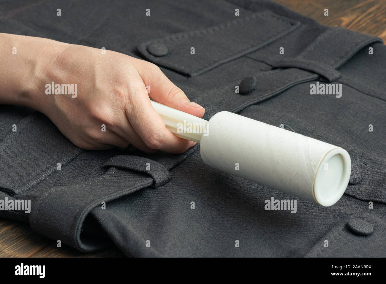 Woman cleaning lint roller hi-res stock photography and images - Alamy