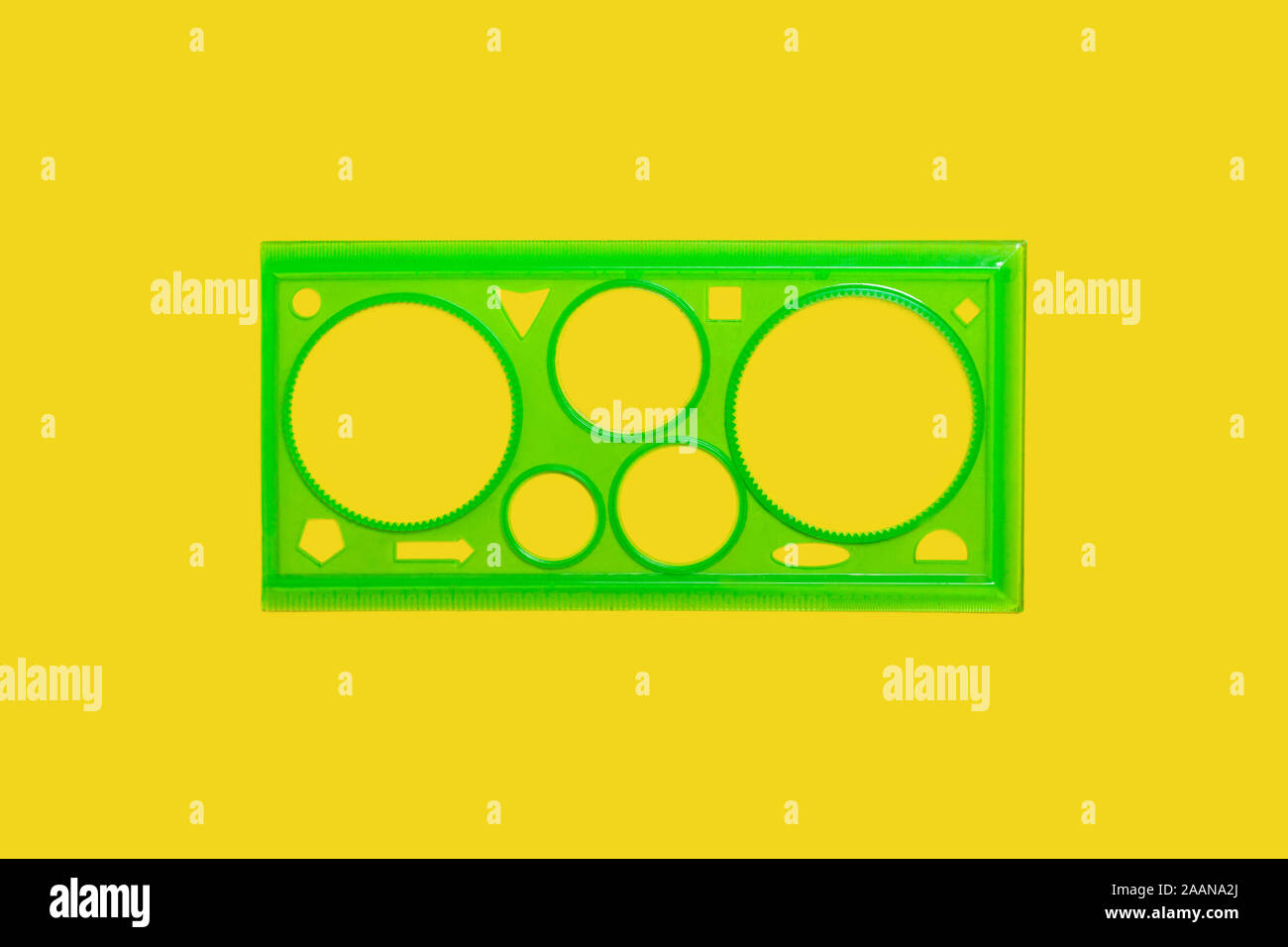 green ruler on a yellow surface Stock Photo - Alamy
