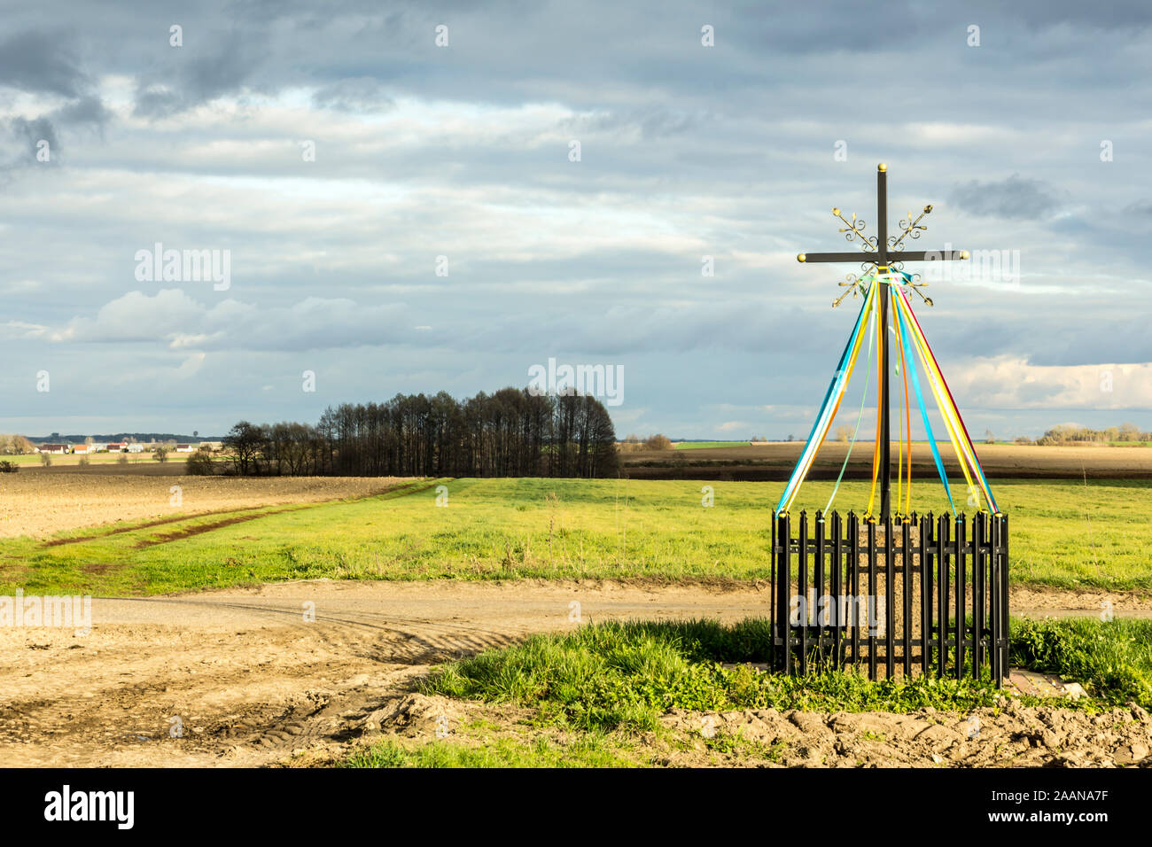 Late autumn. A cross standing at the crossroads, among fields and ...