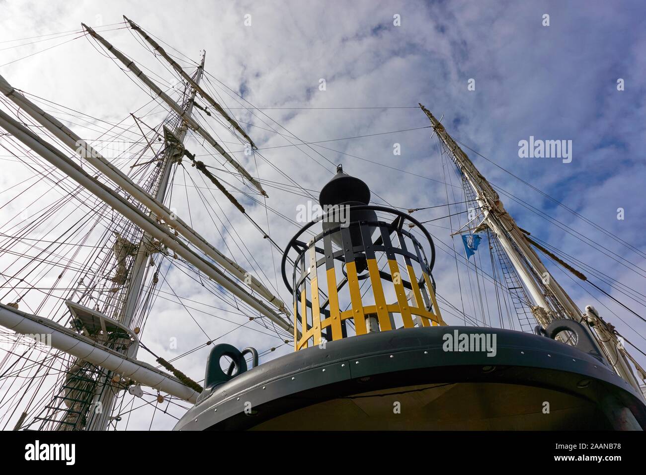Buoy and masts of a historical sailing ship in back light Stock Photo ...