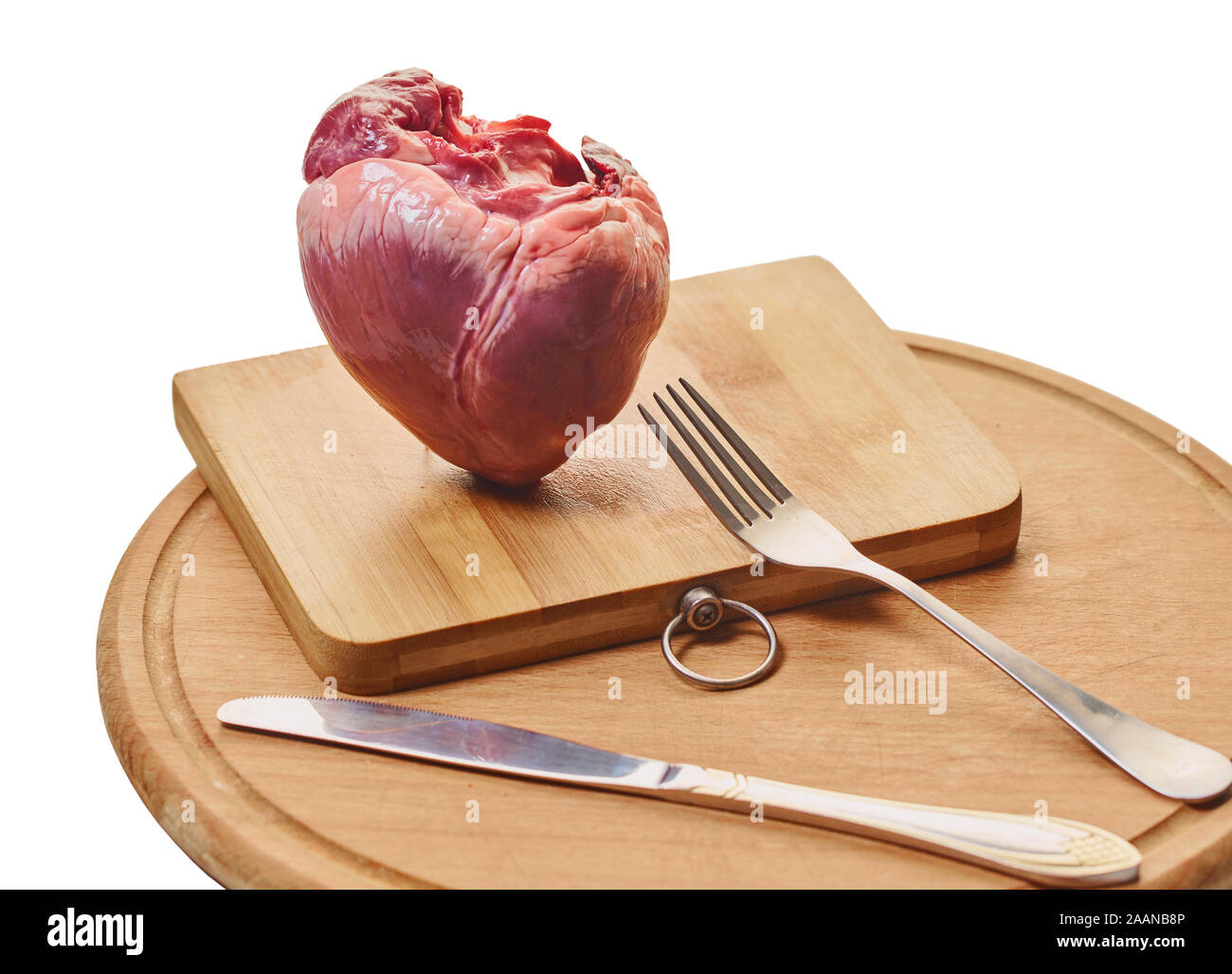 raw heart on a board with cutlery, white isolated background Stock ...