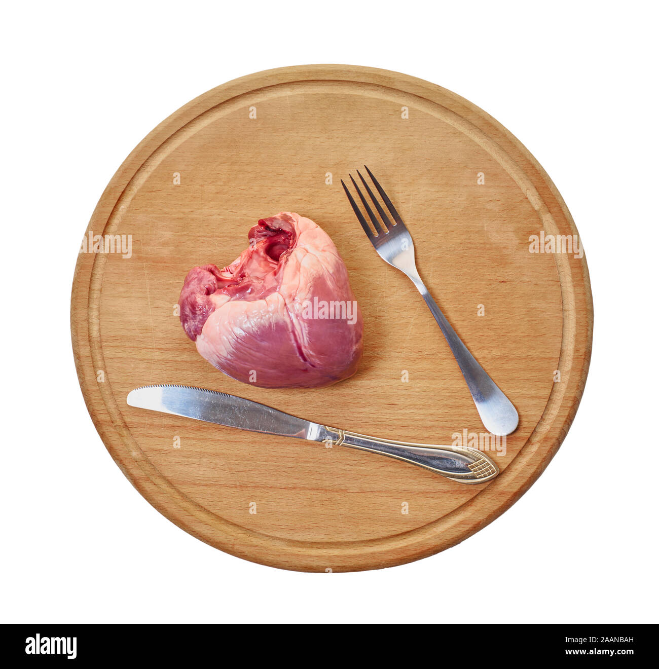 raw heart on a board with cutlery, white isolated background Stock ...