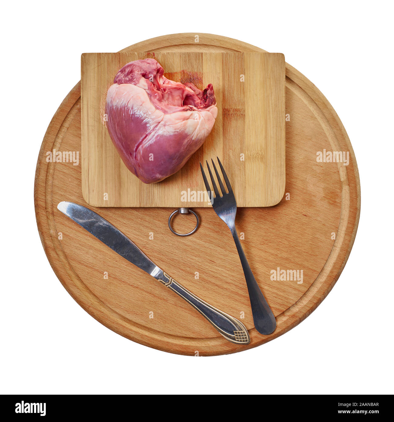 raw heart on a board with cutlery, white isolated background Stock ...