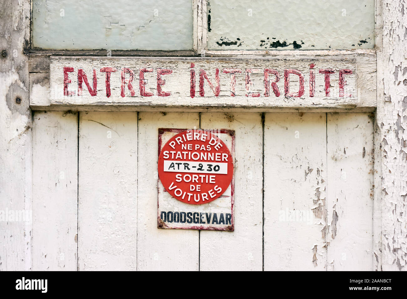 Entree Interdite. Old weathered white door in Belgium with red painted ...