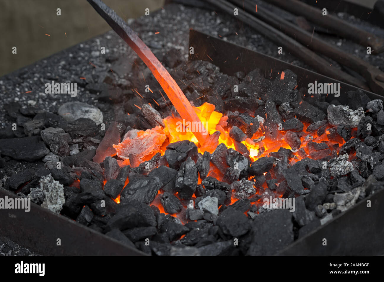 Bar heating for vaking a horseshoe. Embers glow in a iron forge. Fire ...