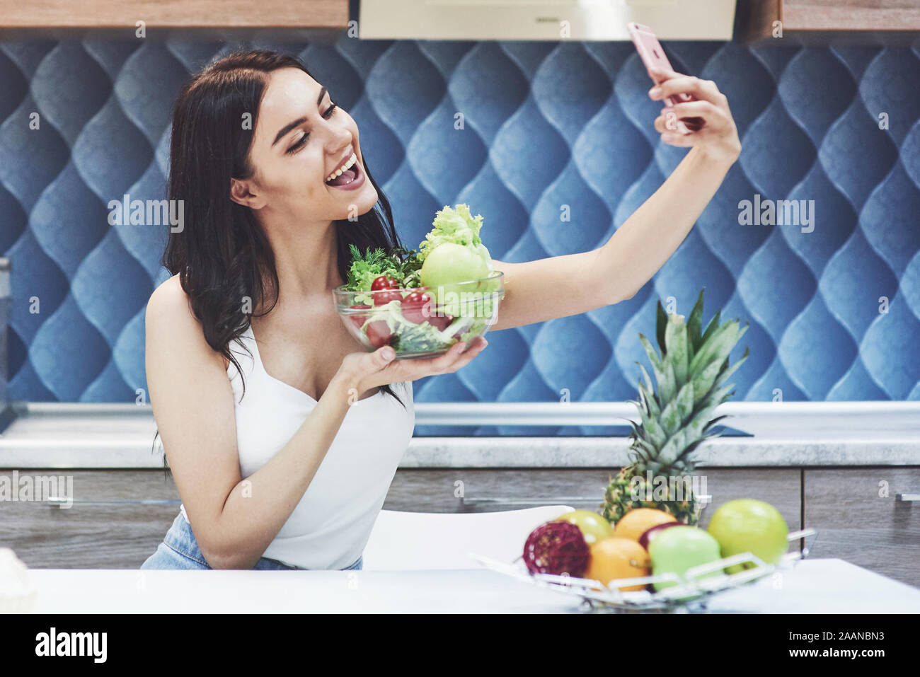Young girl blogger photographs food and promotes healthy eating and ...