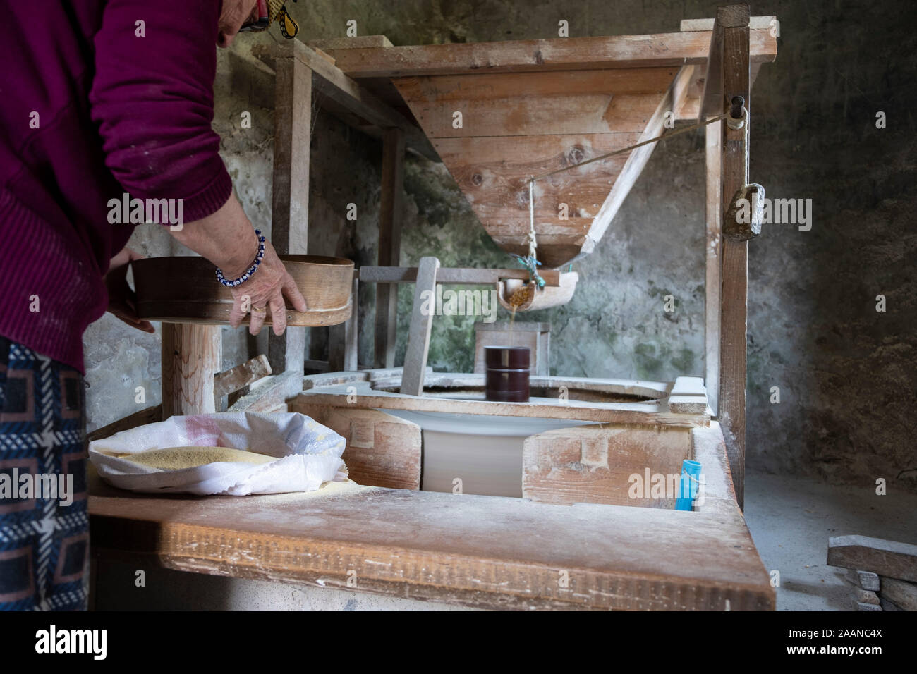 old woman grinding corn in an old water mill in tonya trabzon Stock ...