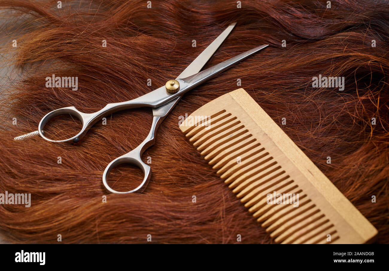 hairdresser scissors and comb on a background of hair Stock Photo - Alamy