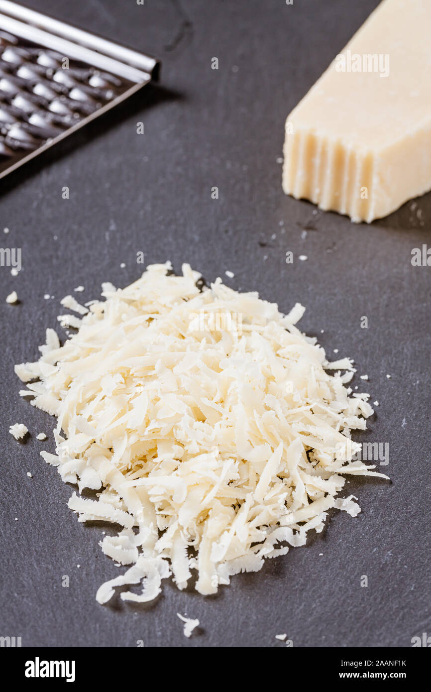 grated parmesan cheese, slate background Stock Photo - Alamy