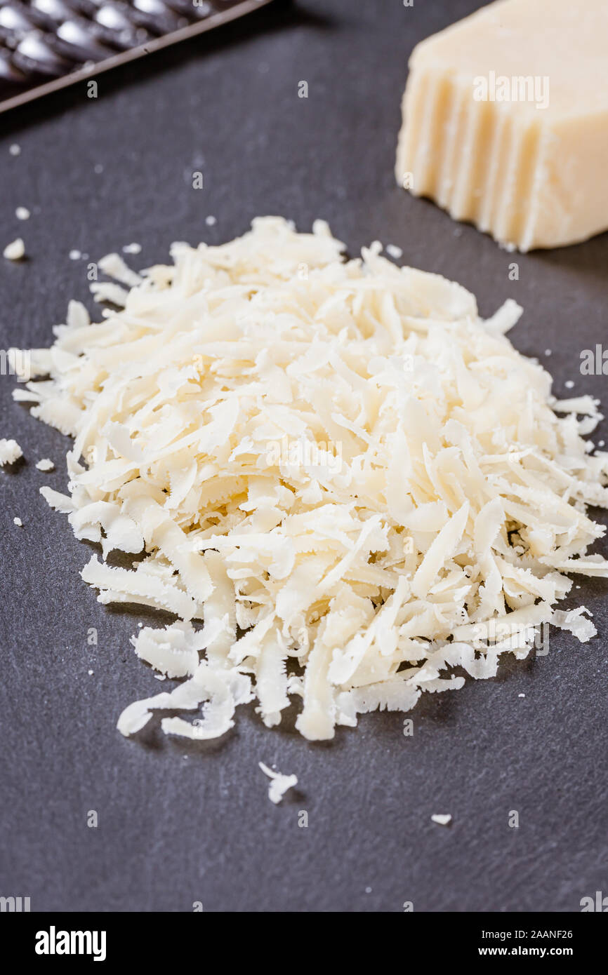 grated parmesan cheese, slate background Stock Photo - Alamy