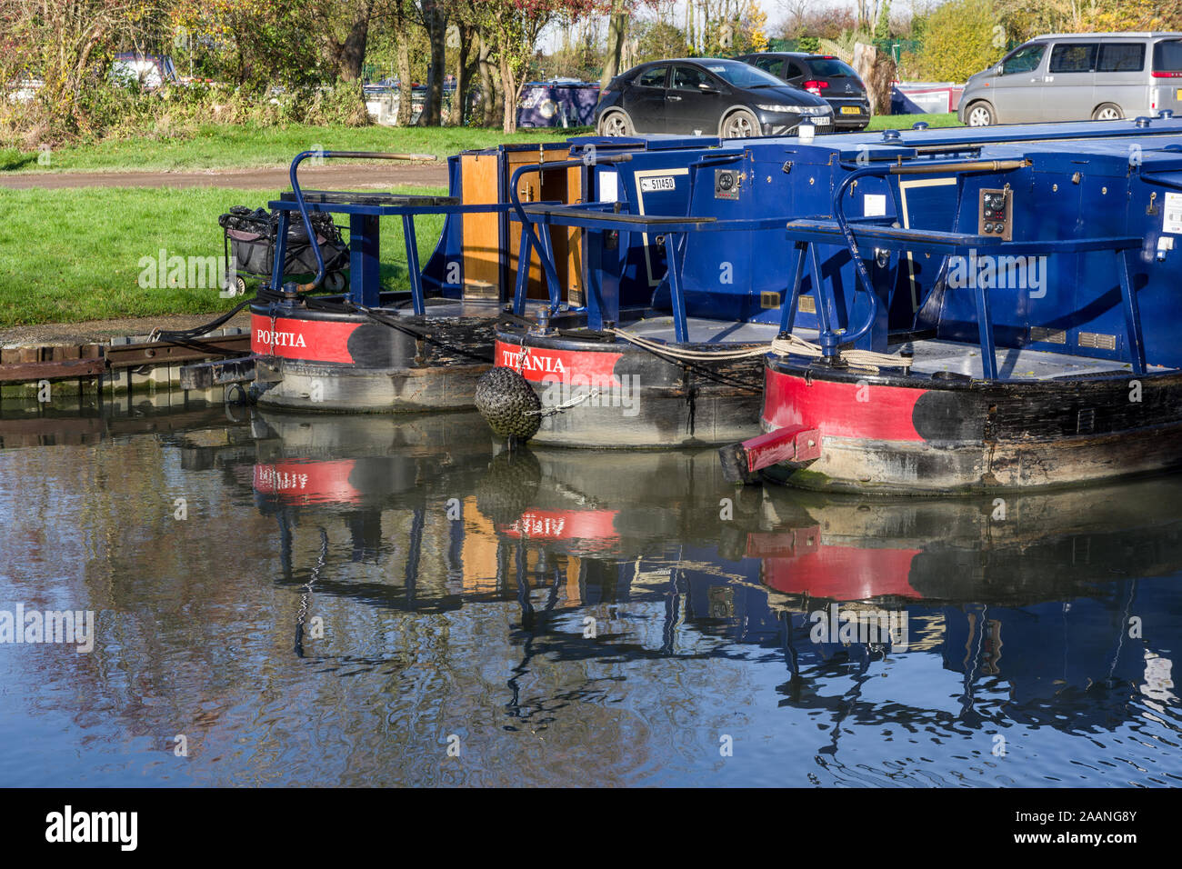 Colourful narrowboats moored on the Grand Union canal at Gayton Marina ...