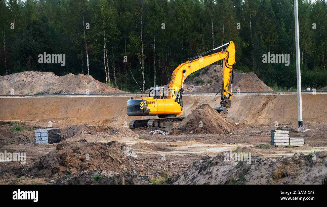 Construction of the highway. Excavator operation Stock Photo - Alamy