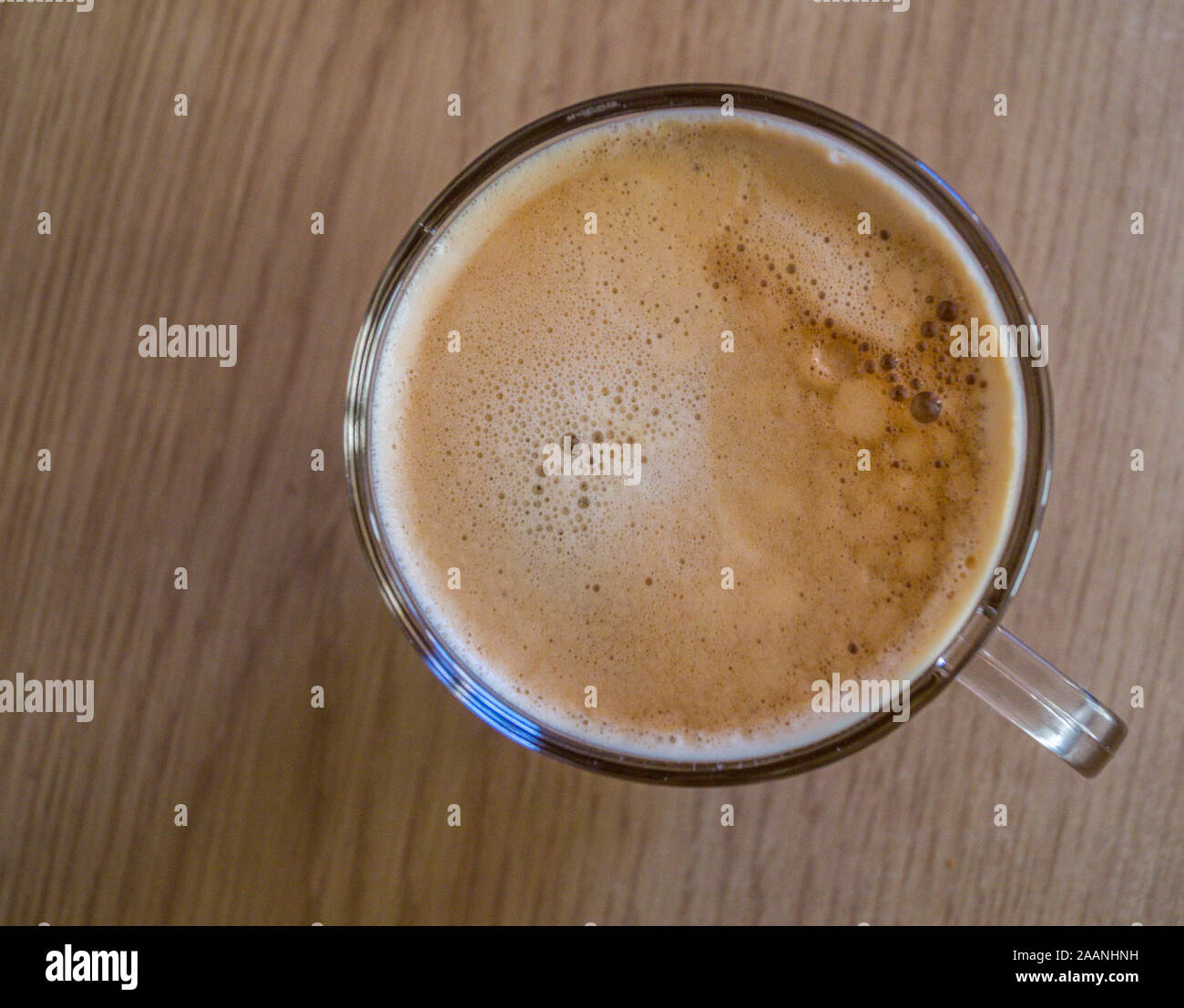 Coffee Time- A top down view of a glass mug of foamy coffee Stock Photo ...
