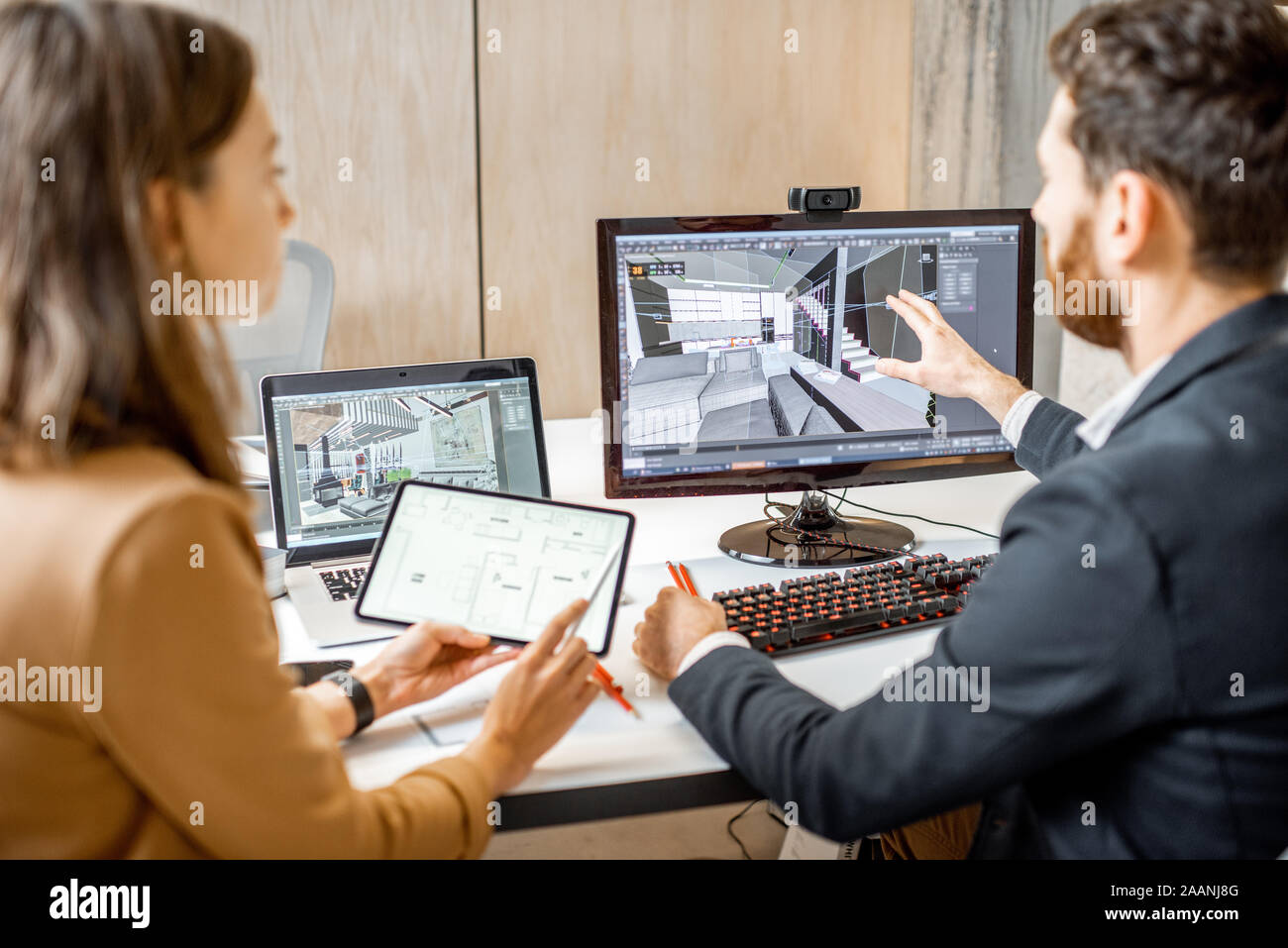 Two creative office employees making interior design on the computer ...