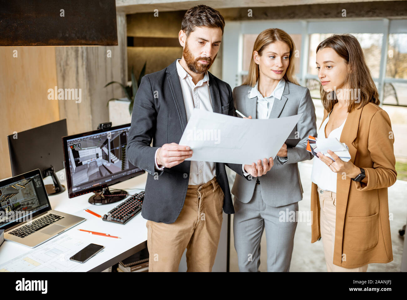 Small group of creative office employees working with a project on the ...
