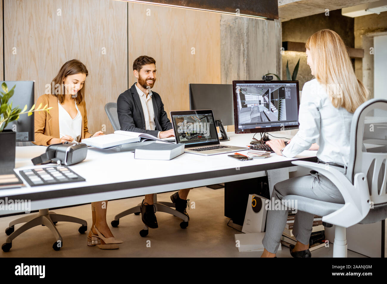 Creative office employees making interior design on the computers ...