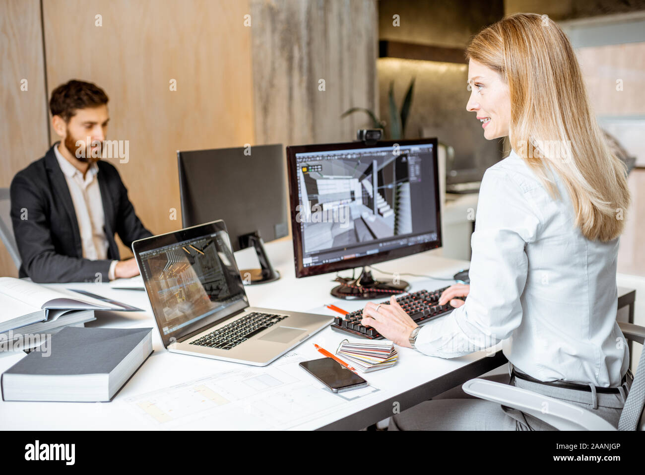 Creative office employees making interior design on the computers ...