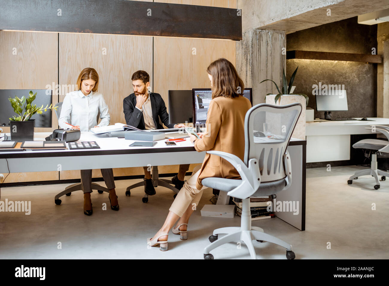 Creative office employees making interior design on the computers ...