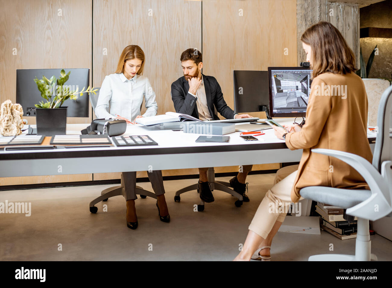Creative office employees making interior design on the computers ...