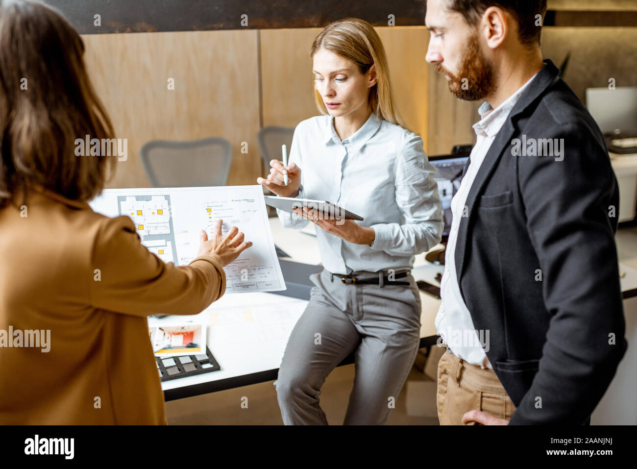 Creative office employees working on some architectural project ...