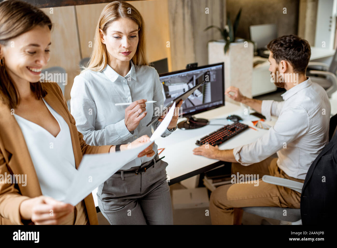 Creative office employees working on some architectural project ...