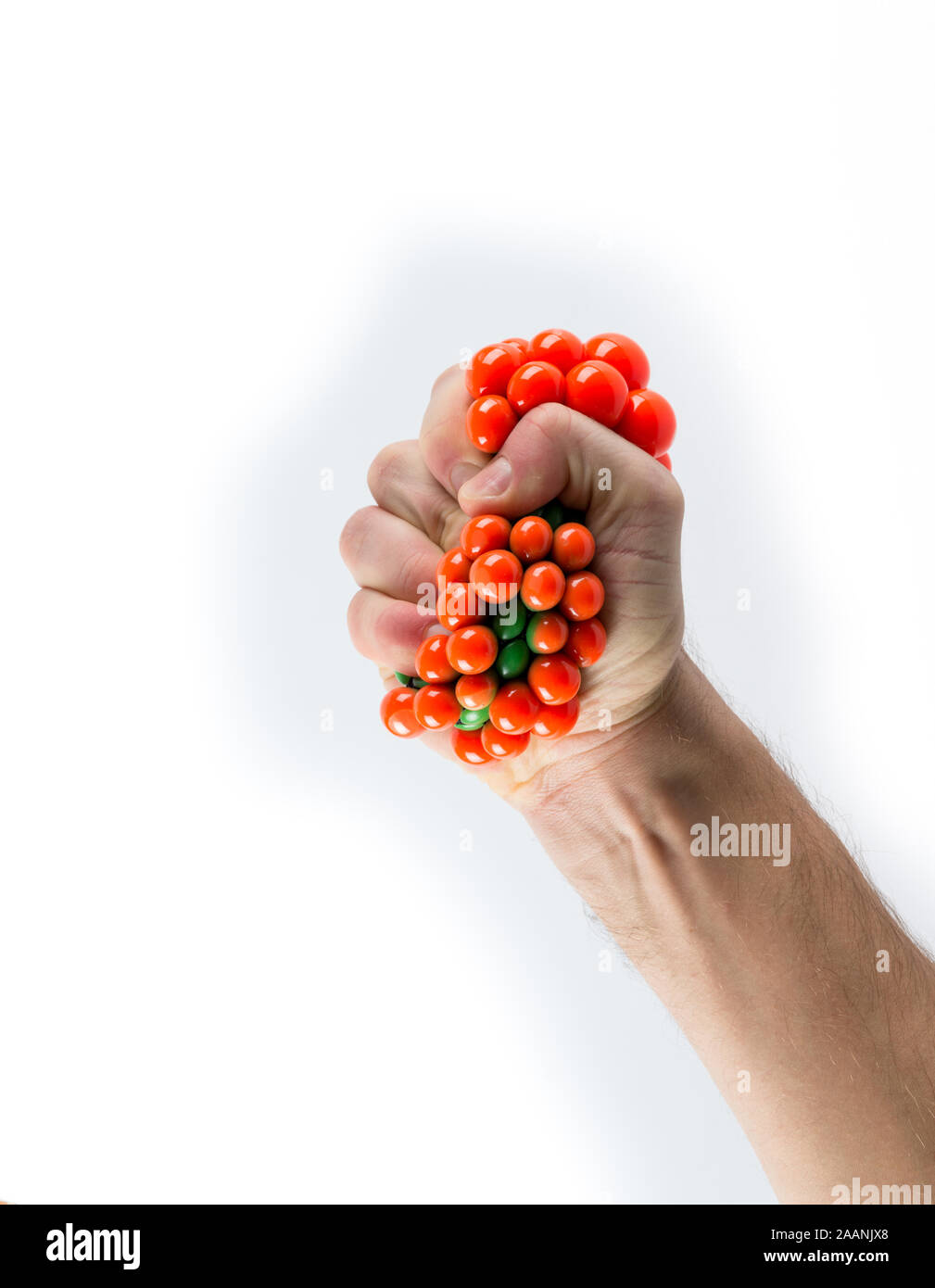Male hand squeezing stress ball over plain background Stock Photo - Alamy
