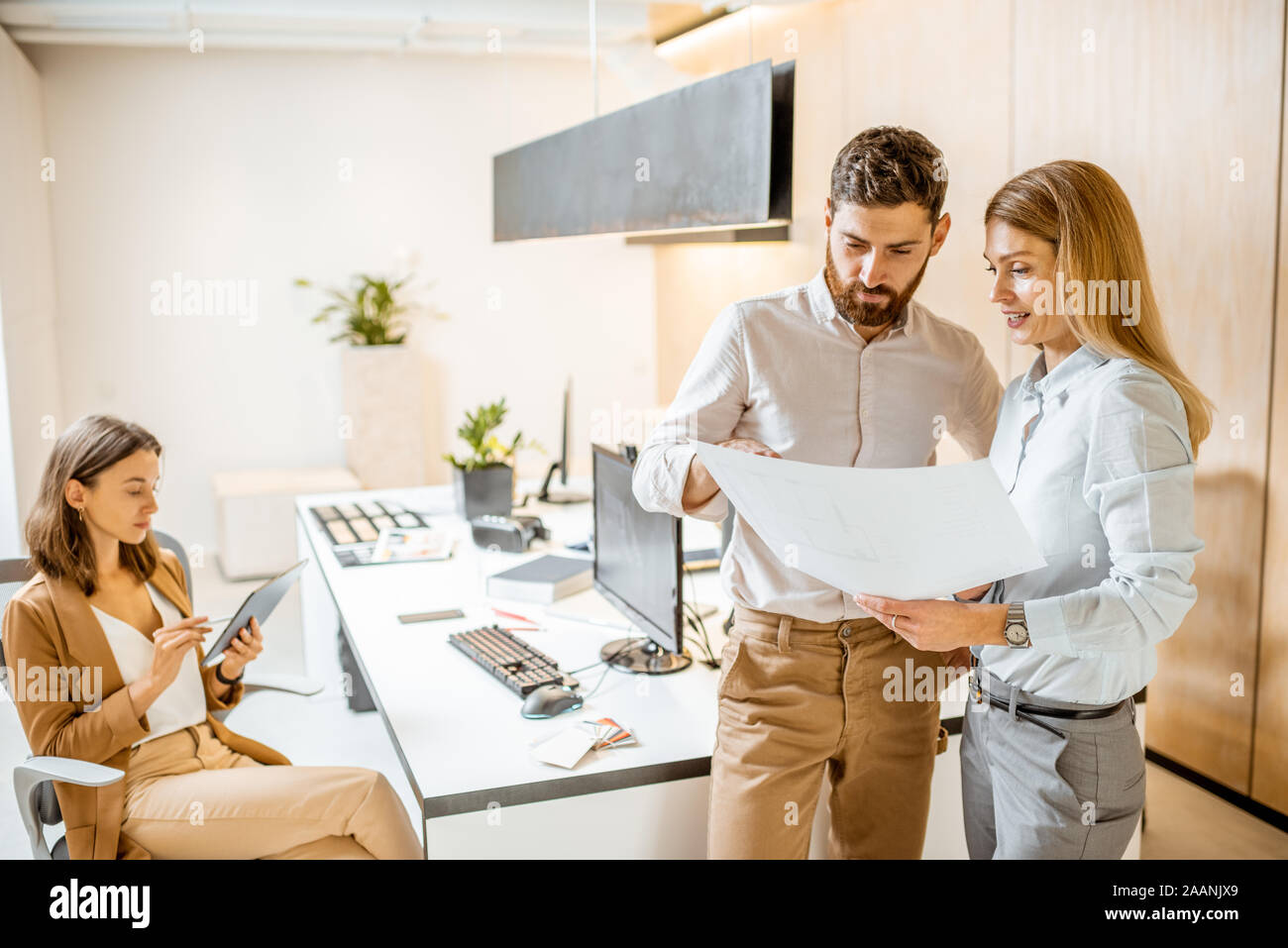 Creative office employees working on some architectural project ...