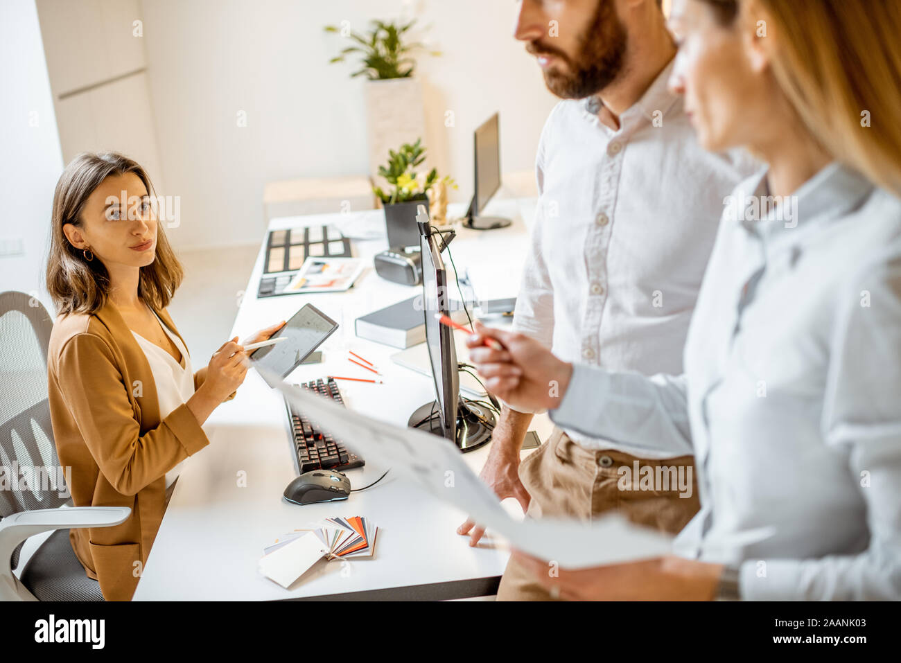 Creative office employees working on some architectural project ...