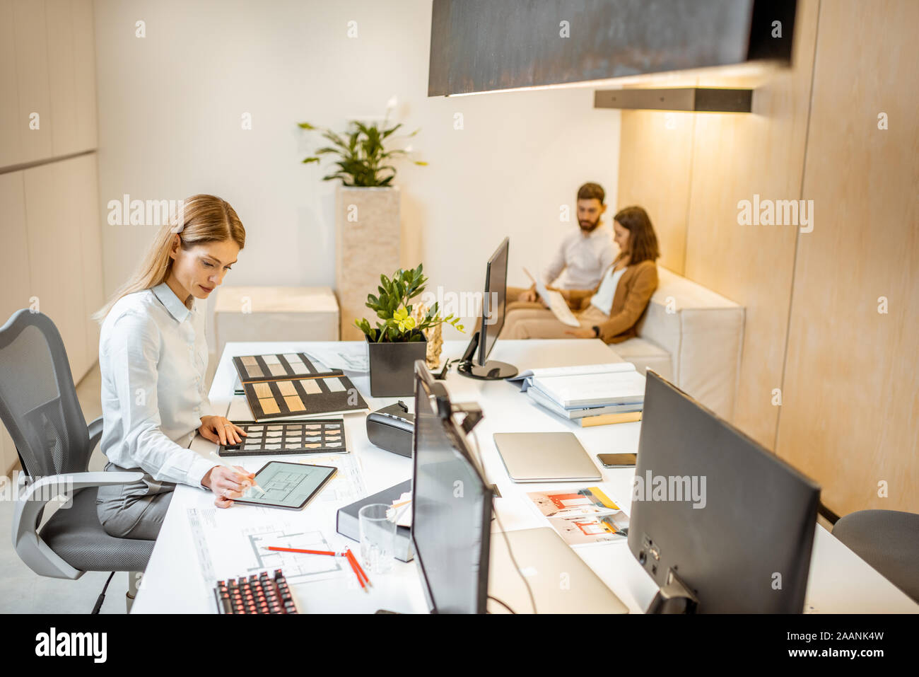 Colleagues doing teamwork in designing hi-res stock photography and ...